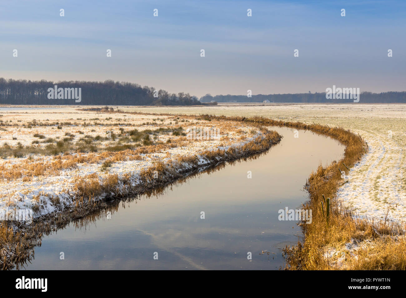 Lowland river winter landscape with thin layer of snow in Koningsdiep ...
