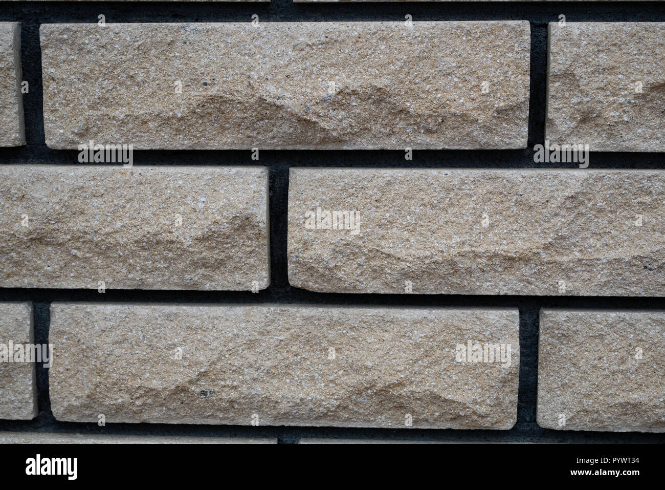 close up wall made of accurate white stone bricks tiles with concrete ...