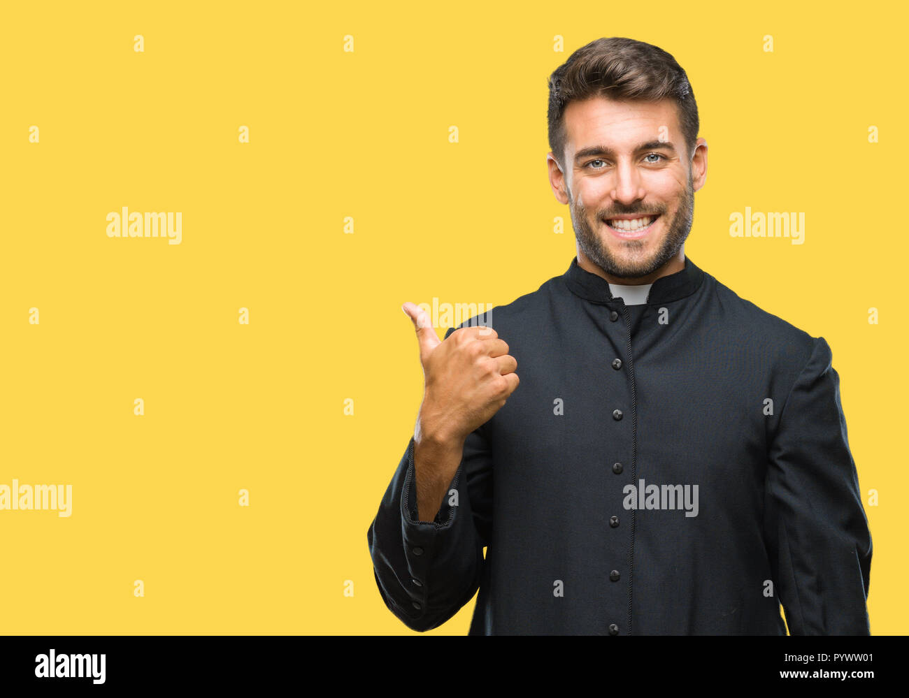 Young catholic christian priest man over isolated background smiling ...