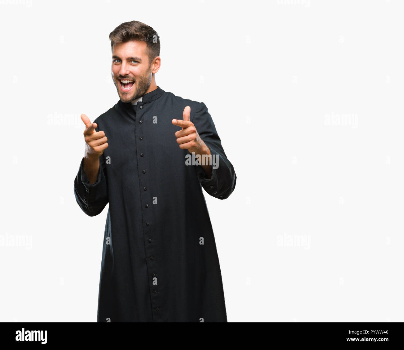 Young catholic christian priest man over isolated background pointing ...