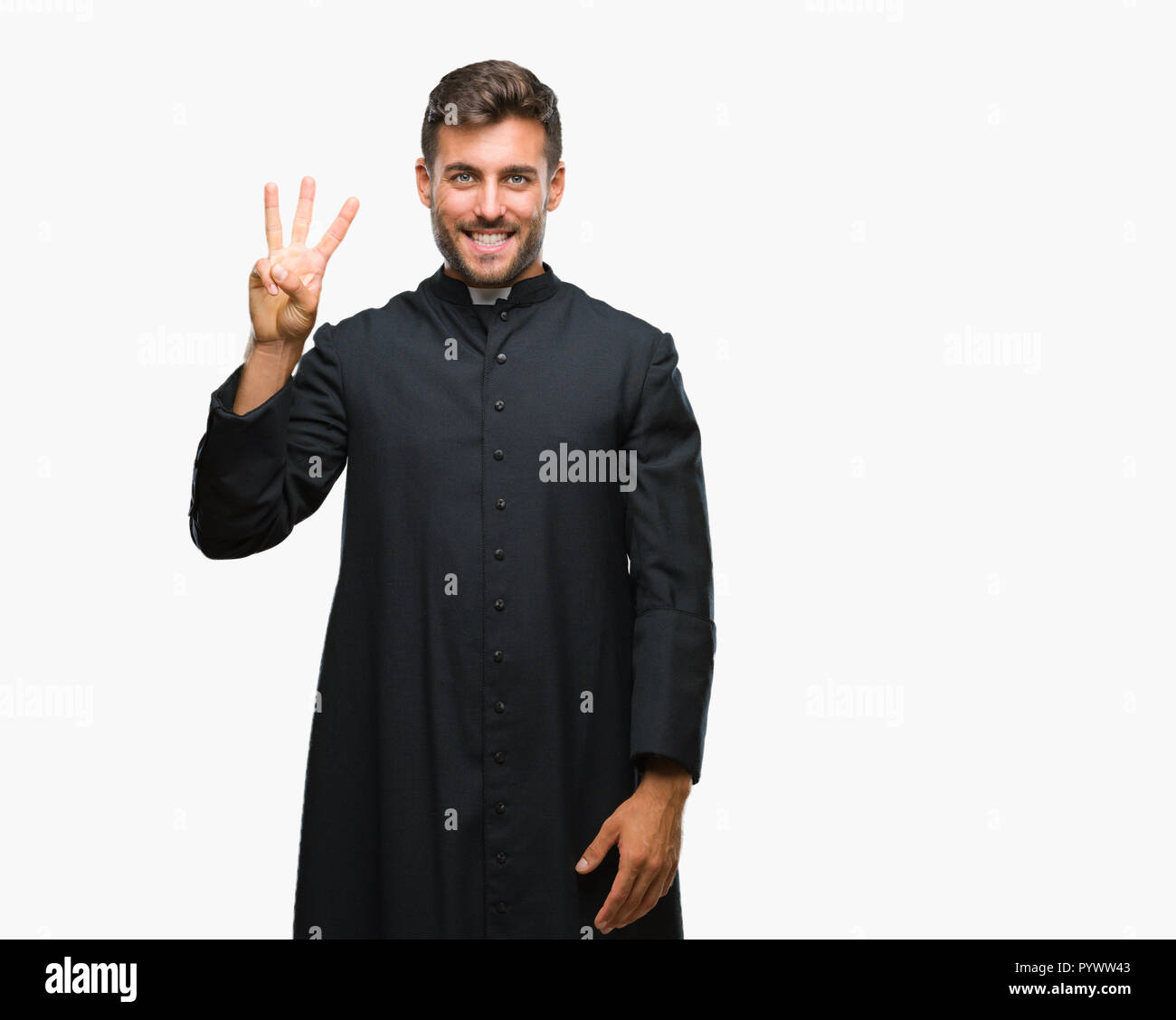 Young catholic christian priest man over isolated background showing ...