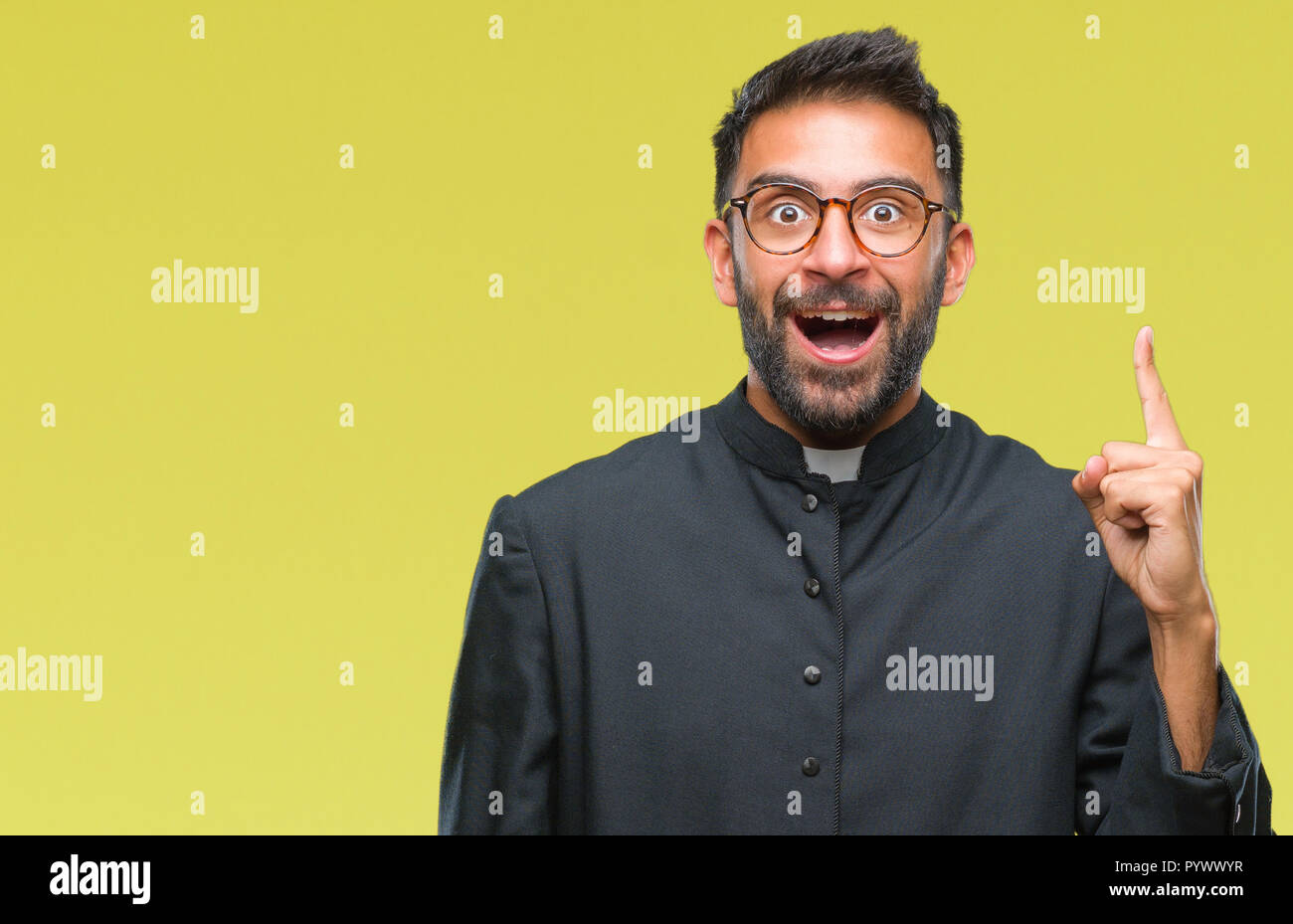 Adult hispanic catholic priest man over isolated background pointing ...
