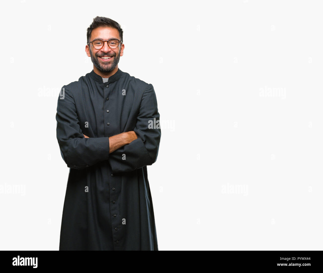 Adult hispanic catholic priest man over isolated background happy face ...