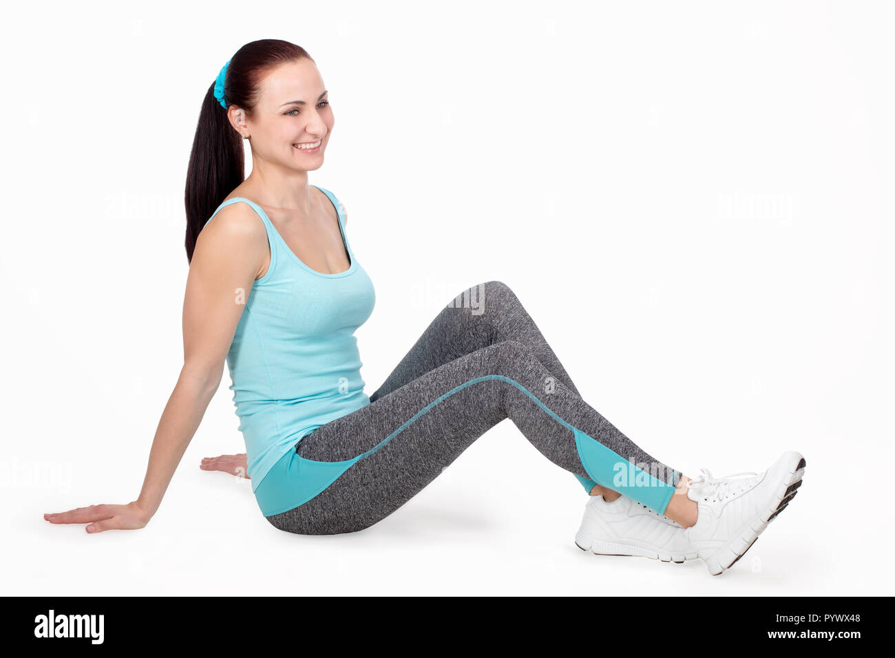 Fitness sports woman relaxing after workout sitting Stock Photo - Alamy