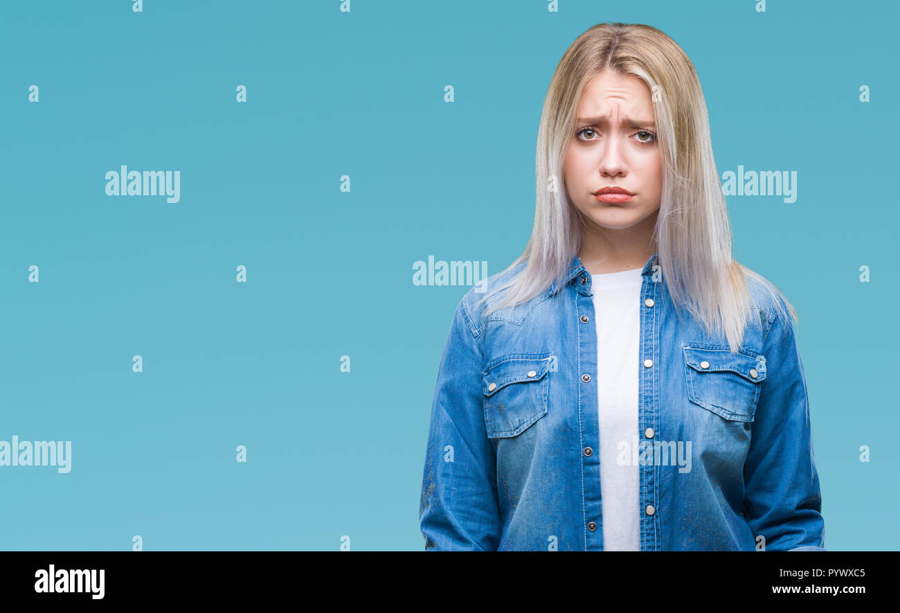 Young blonde woman over isolated background depressed and worry for ...