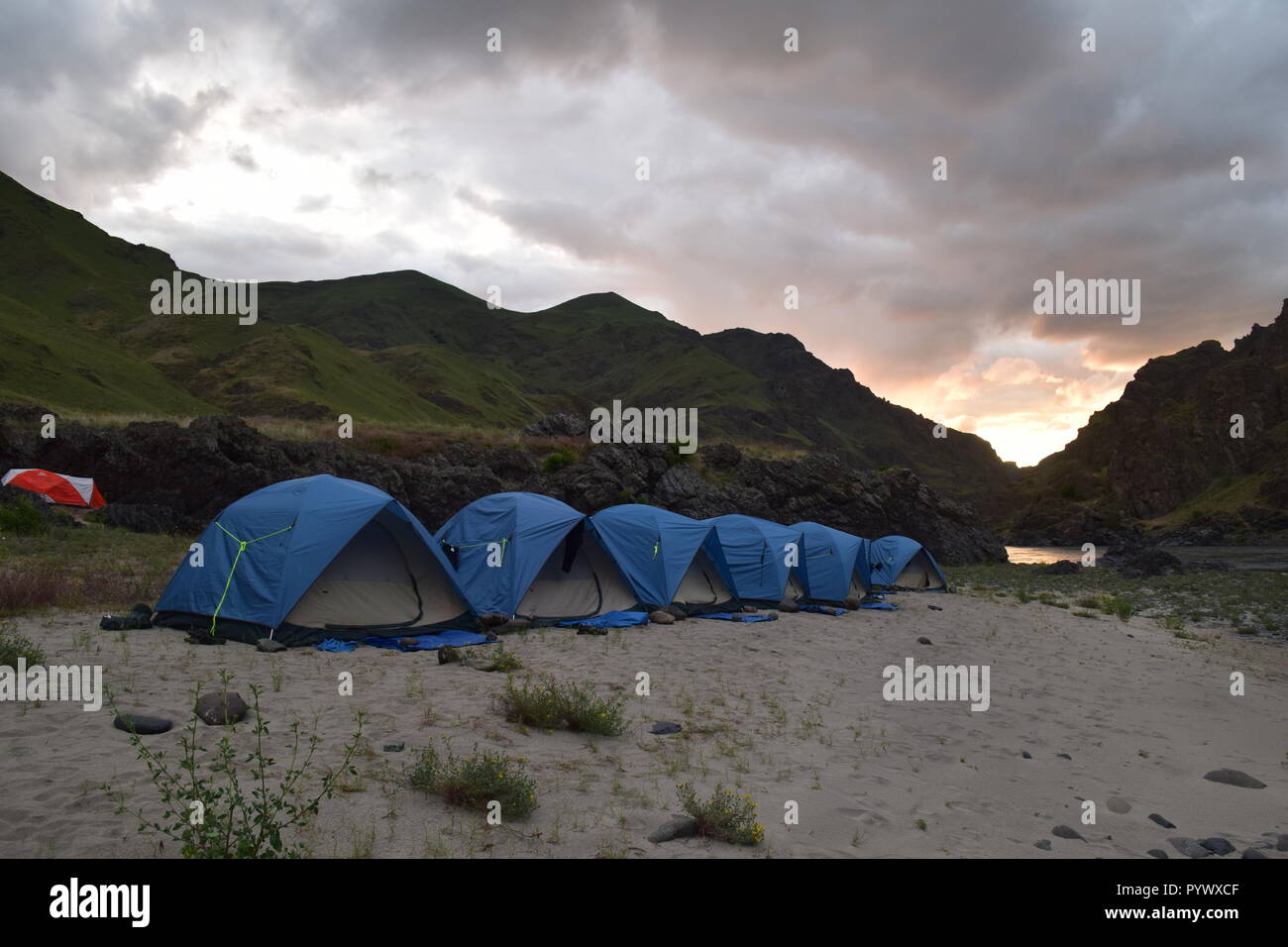 line of tents in a canyon with sunset Stock Photo - Alamy