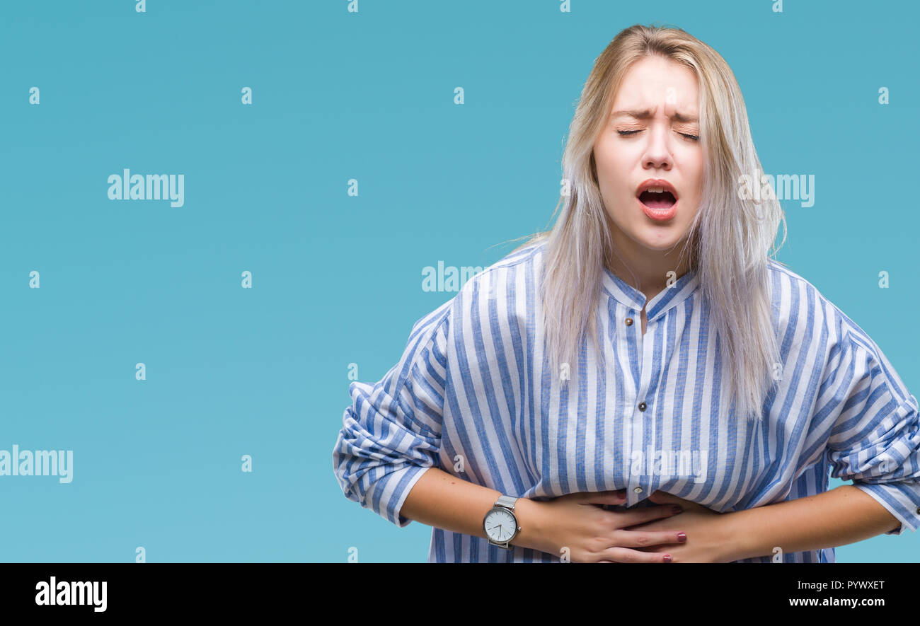Young blonde woman over isolated background with hand on stomach ...