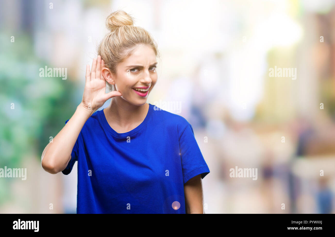 Young beautiful blonde and blue eyes woman wearing blue t-shirt over ...