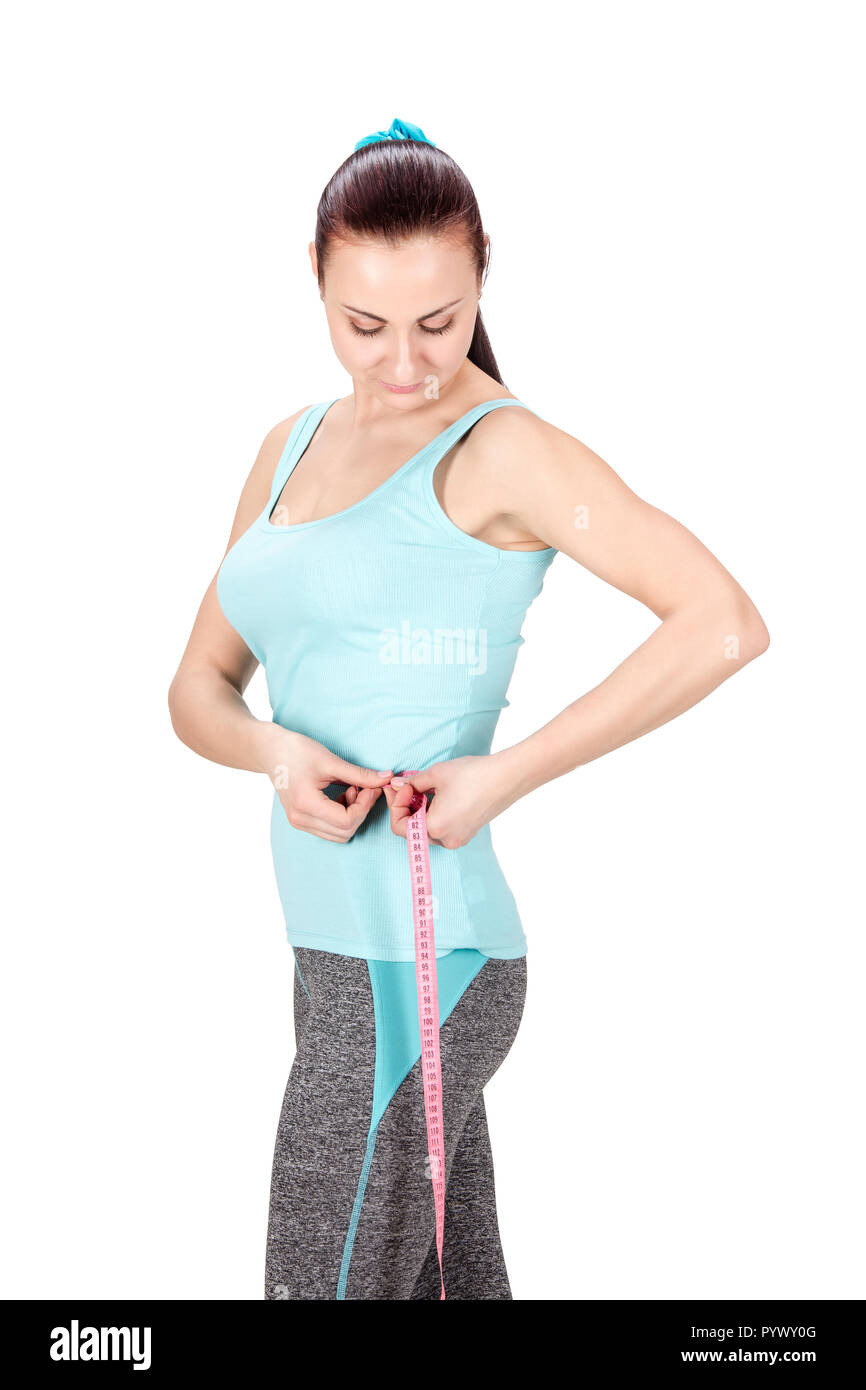 Attractive woman measuring her hips with tape measure Stock Photo - Alamy