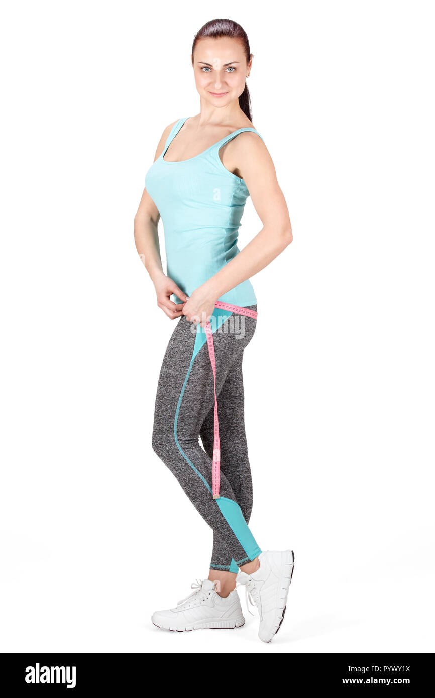 Attractive woman measuring her hips with tape measure Stock Photo - Alamy