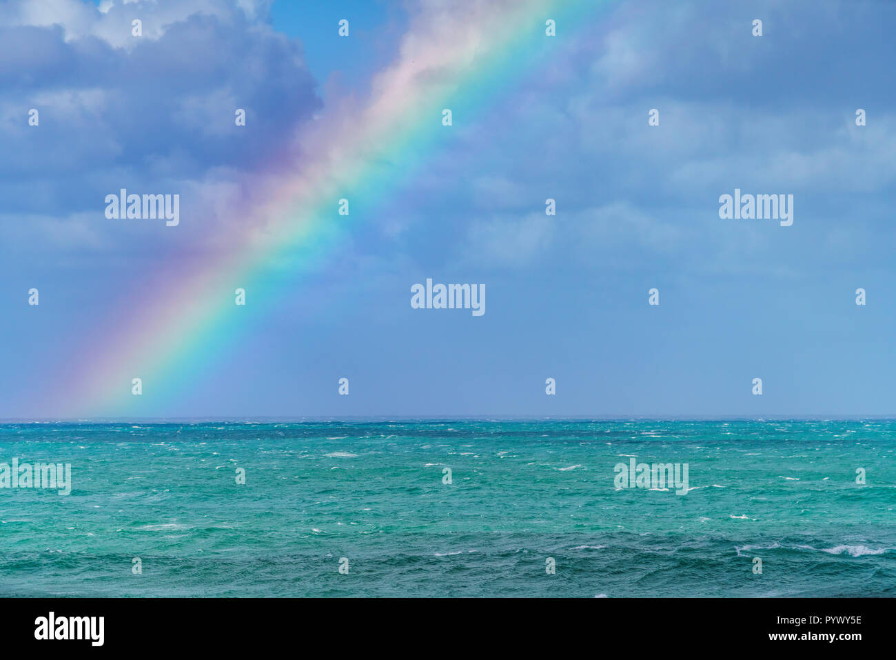 Rainbow in the ocean after rain and thunderstorms. Colorful views of ...