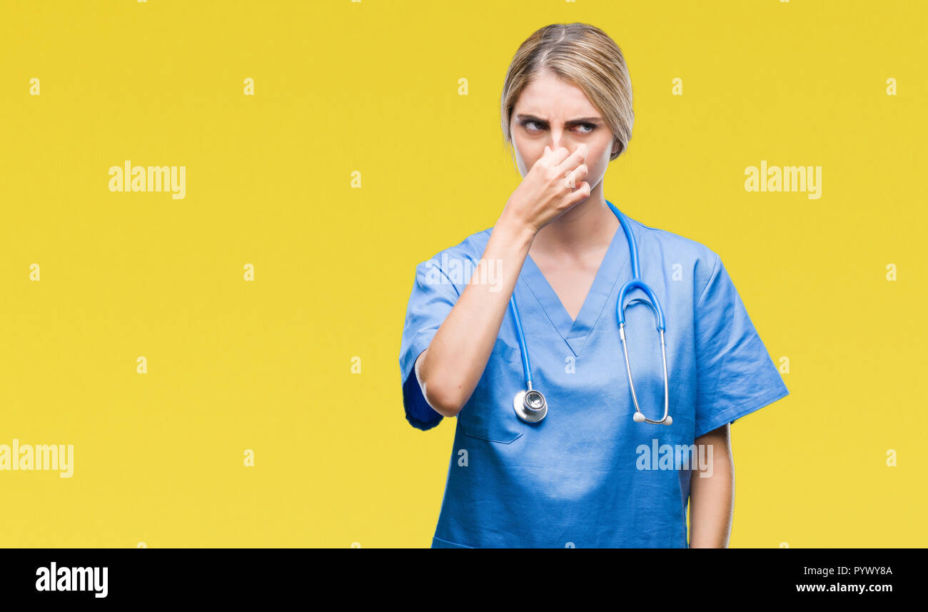Young beautiful blonde doctor surgeon nurse woman over isolated ...