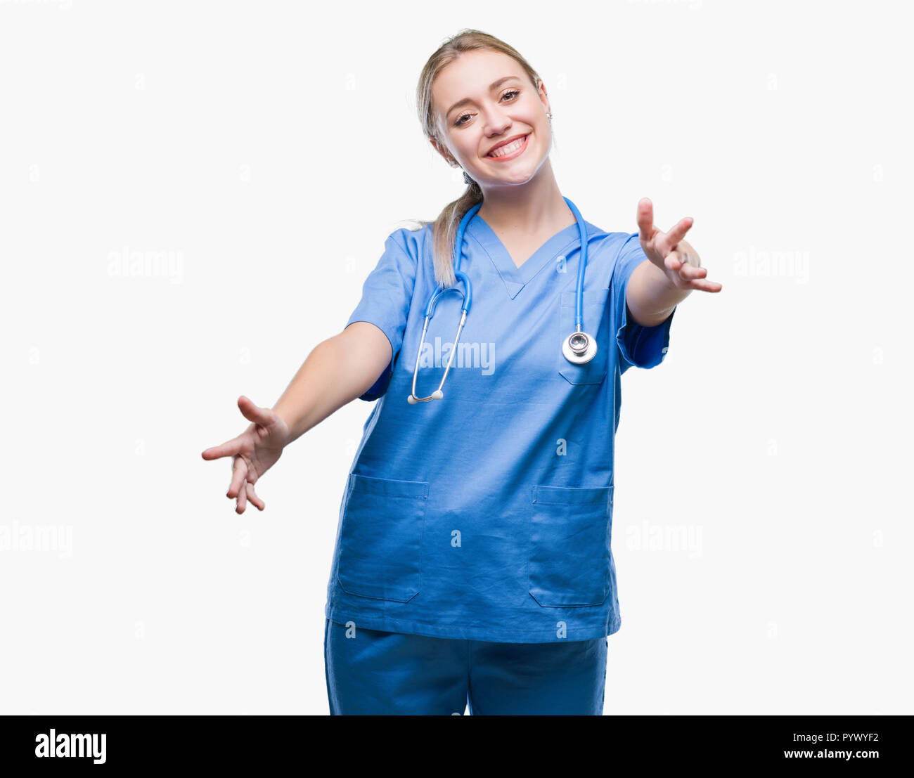 Young blonde surgeon doctor woman over isolated background looking at ...