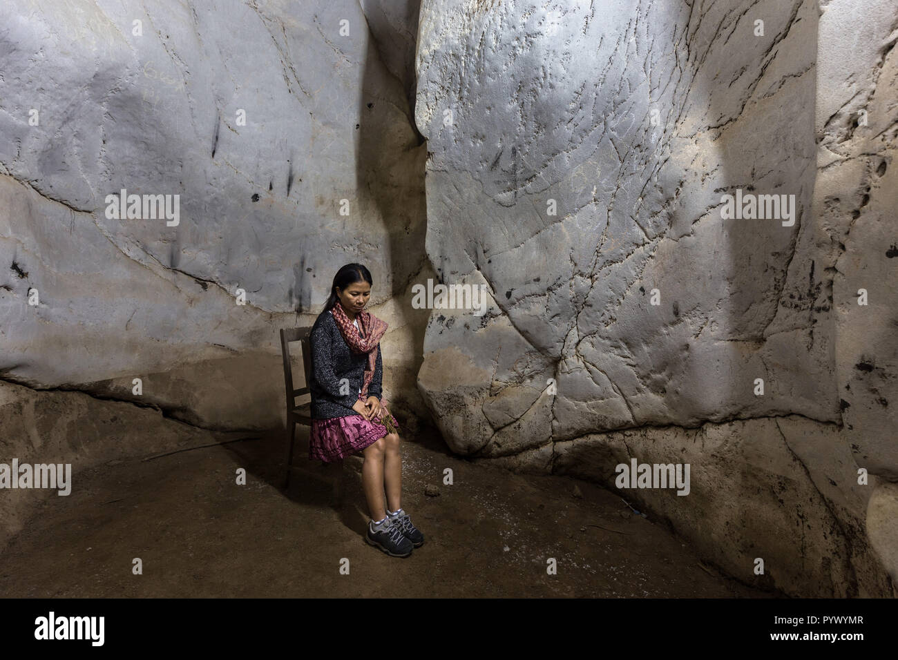 Abandoned lonely woman sitting on a chair in a cave Stock Photo - Alamy