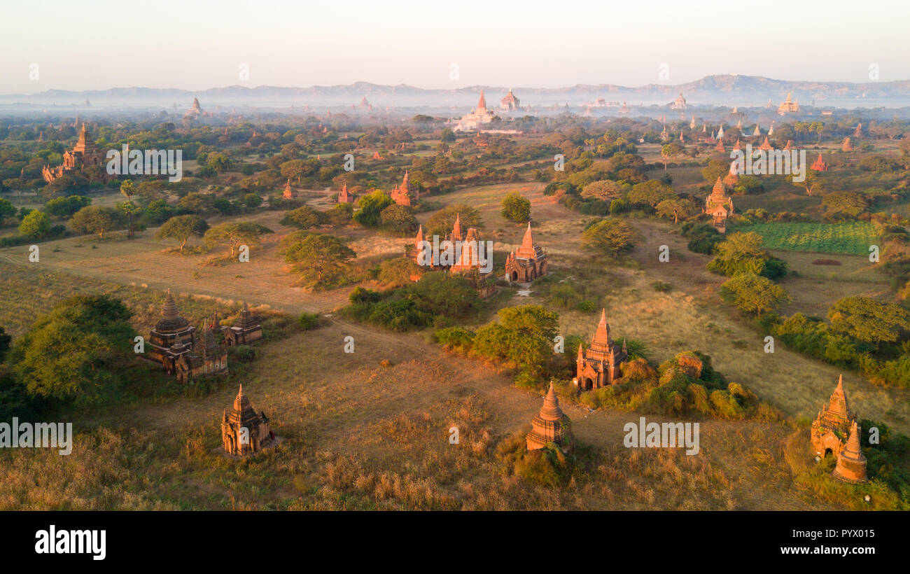 Aerial view of ancient pagodas in the plain of Bagan at sunrise ...