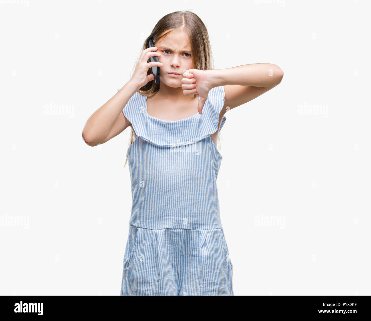 Young beautiful girl talking on the phone over isolated background with ...
