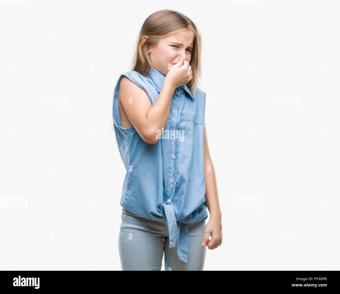 Young beautiful girl over isolated background smelling something stinky ...