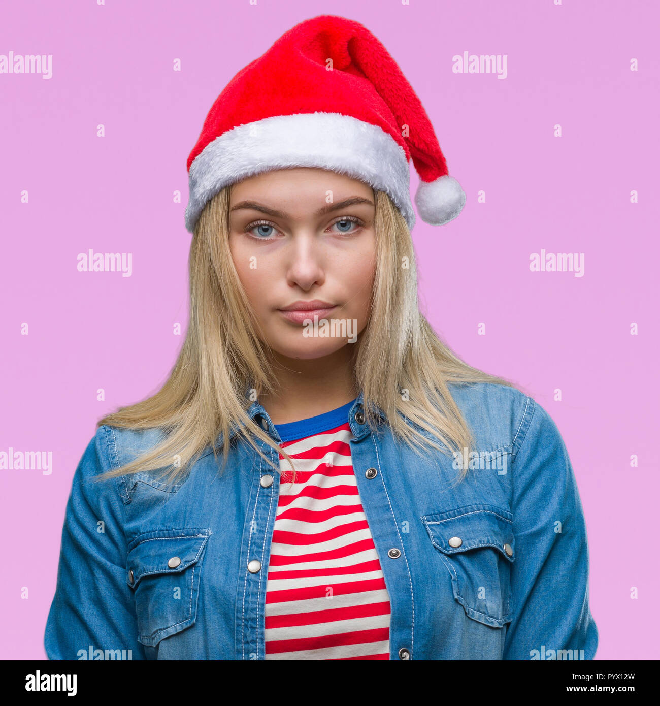 Young caucasian woman wearing christmas hat over isolated background ...