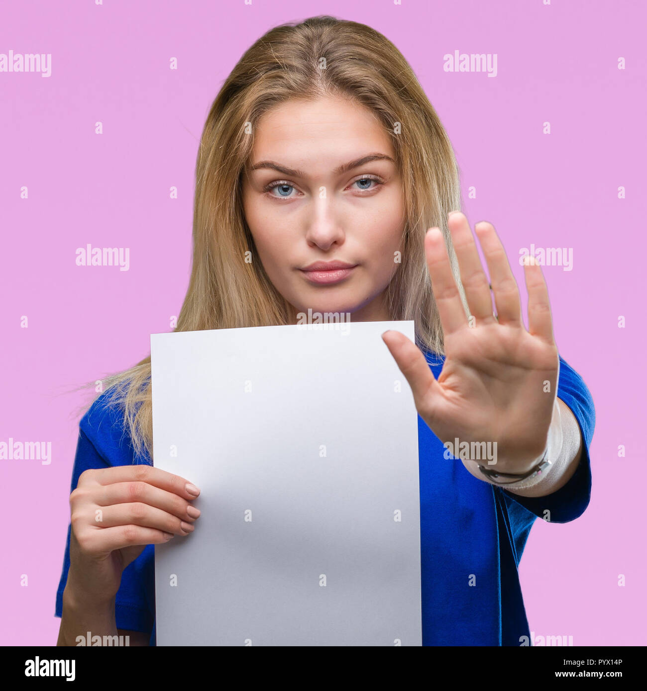 Young caucasian woman holding blank paper sheet over isolated ...