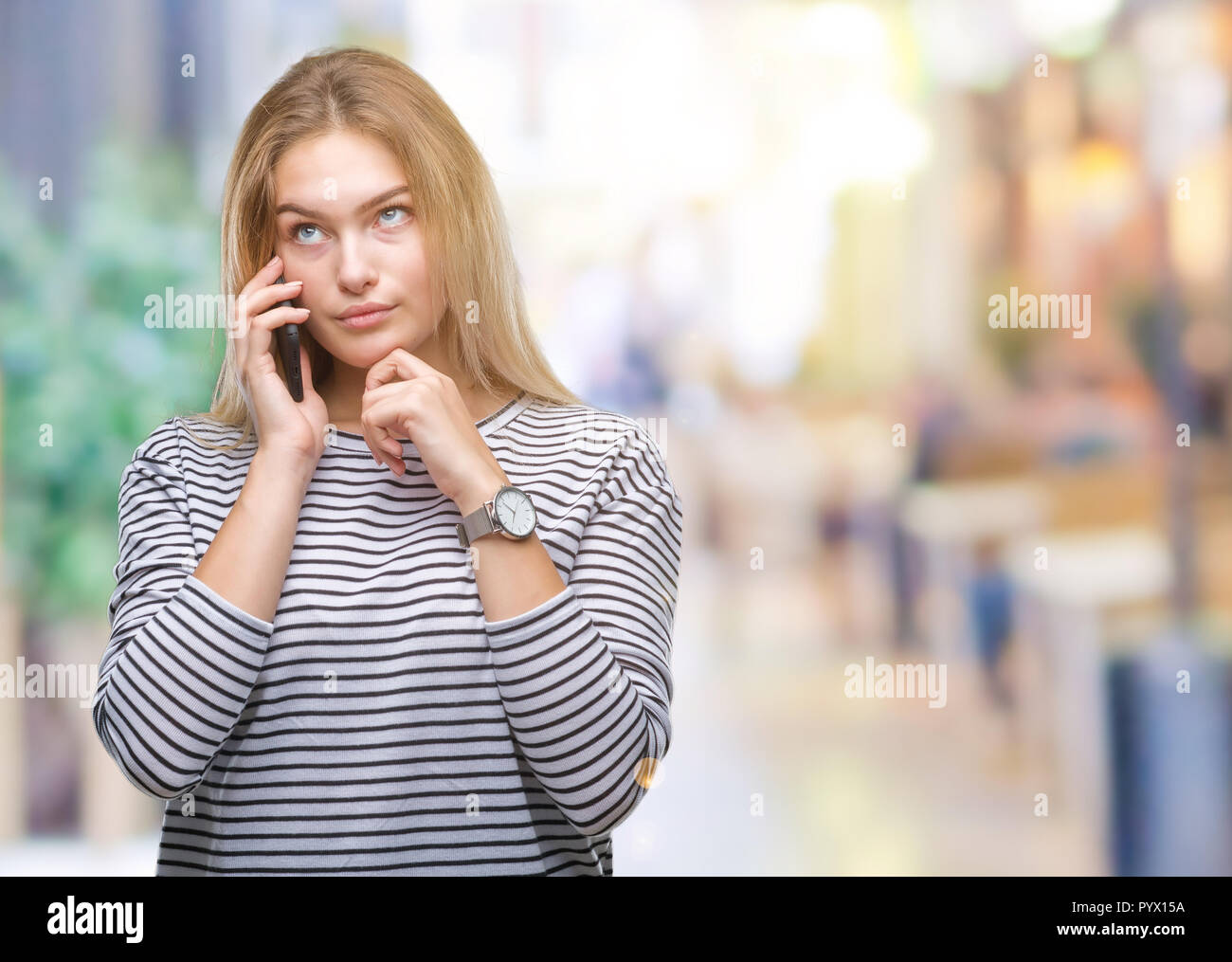Young caucasian woman showing smartphone screen over isolated ...