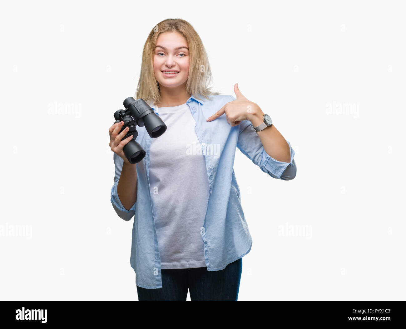 Young caucasian woman holding binoculars over isolated background with ...