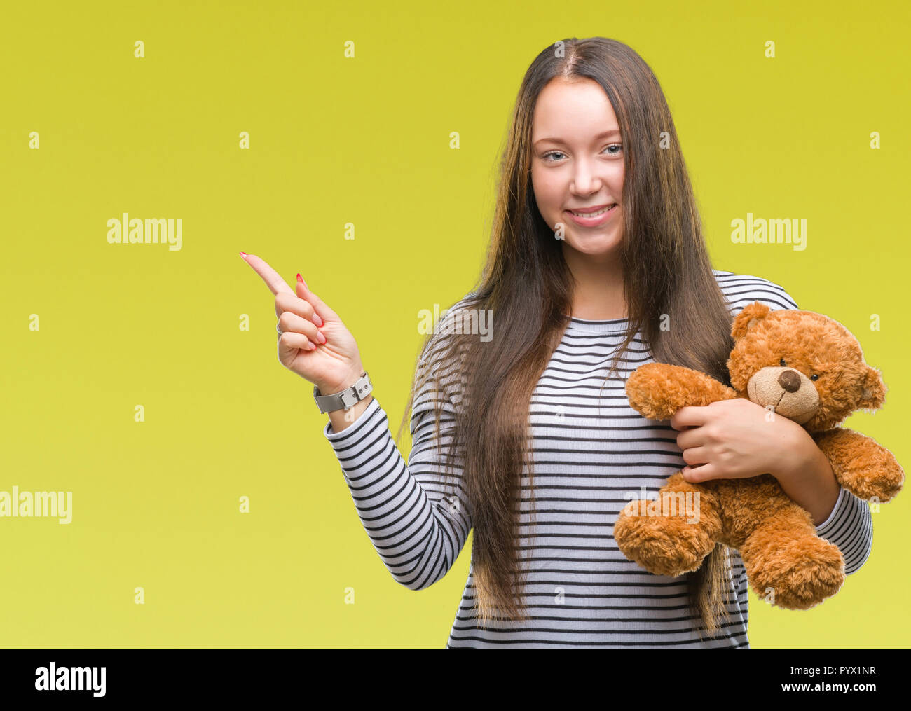 Young caucasian woman holding teddy bear over isolated background very ...