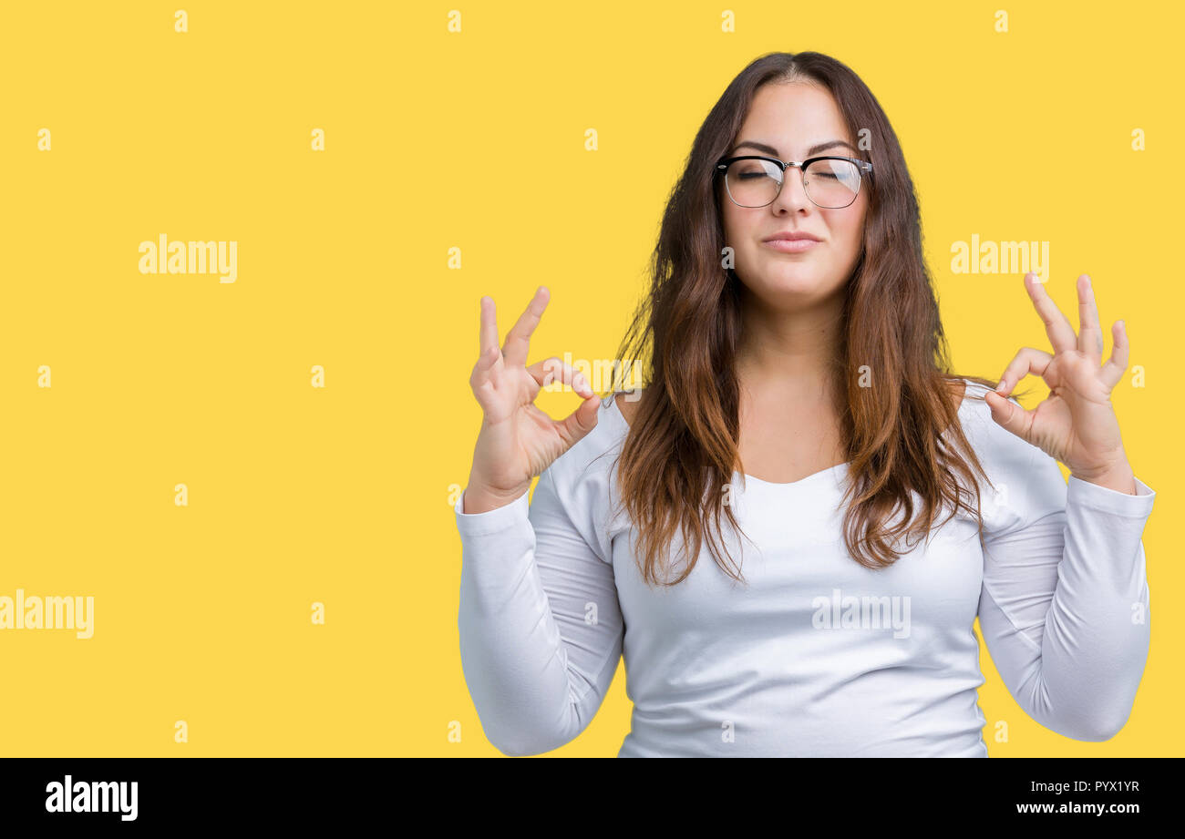 Beautiful plus size young woman over isolated background relax and ...