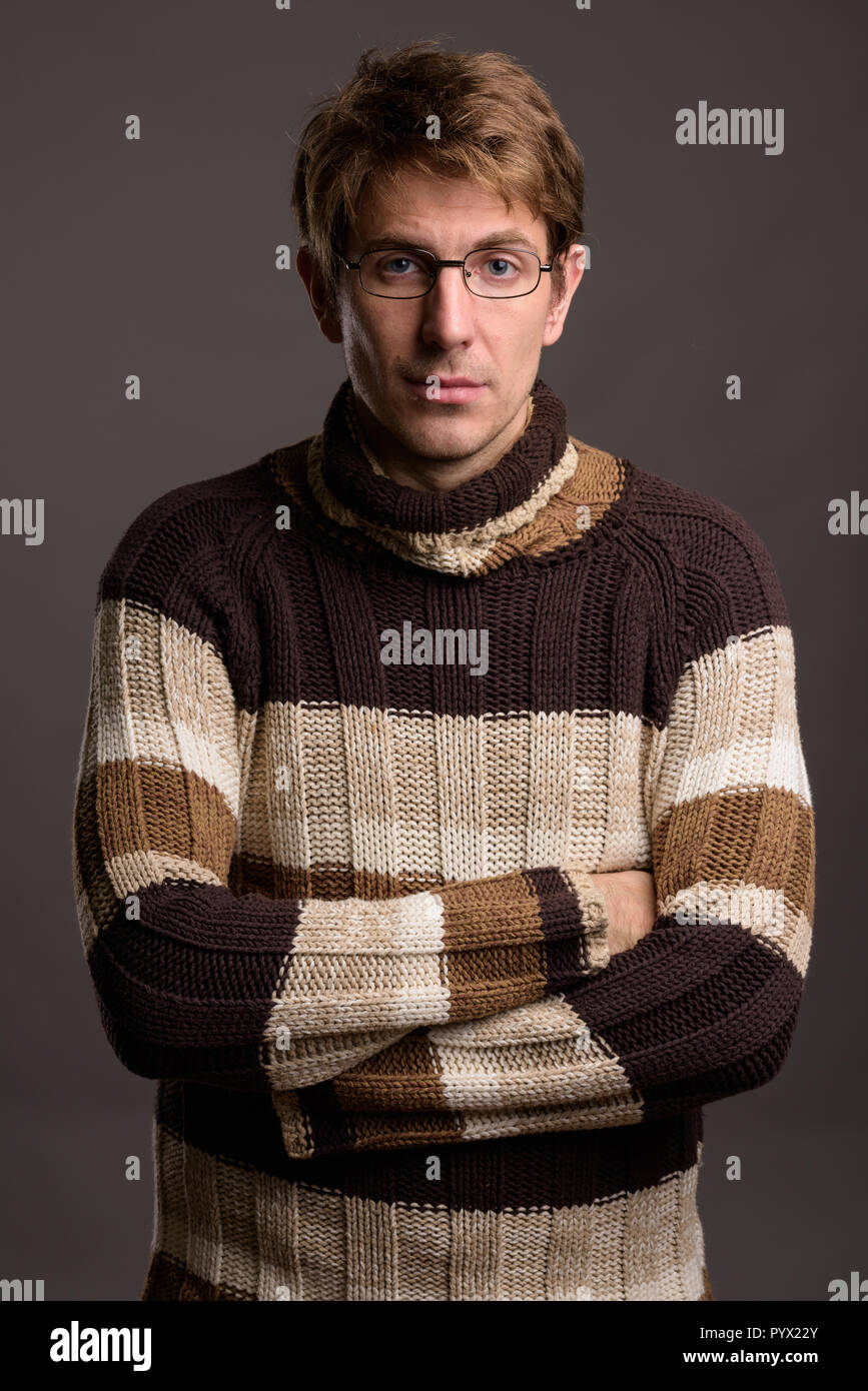 Handsome man wearing eyeglasses against gray background Stock Photo - Alamy