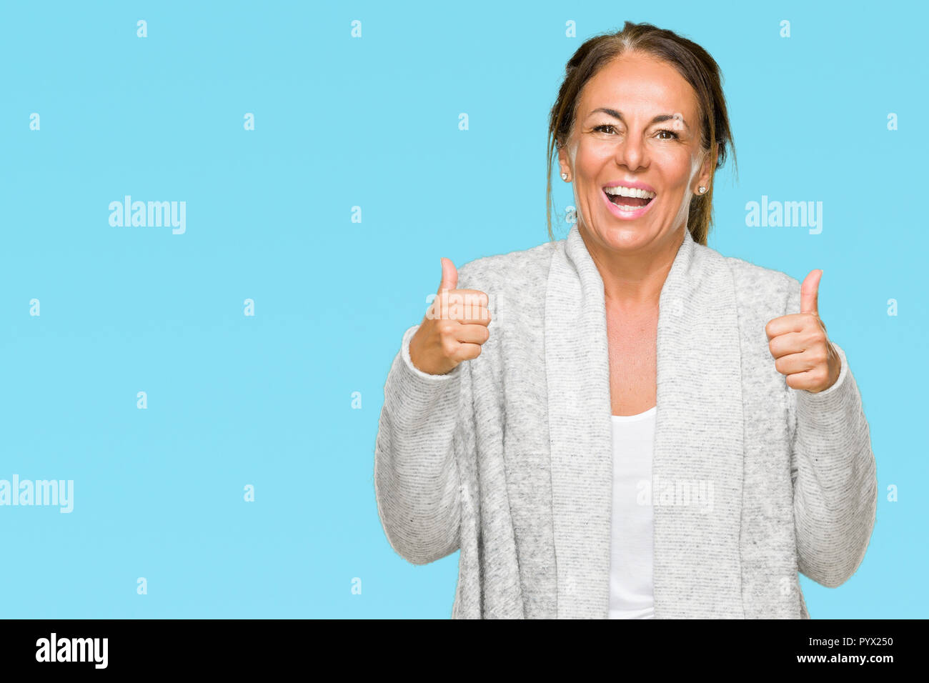 Beautiful middle age adult woman wearing winter sweater over isolated ...