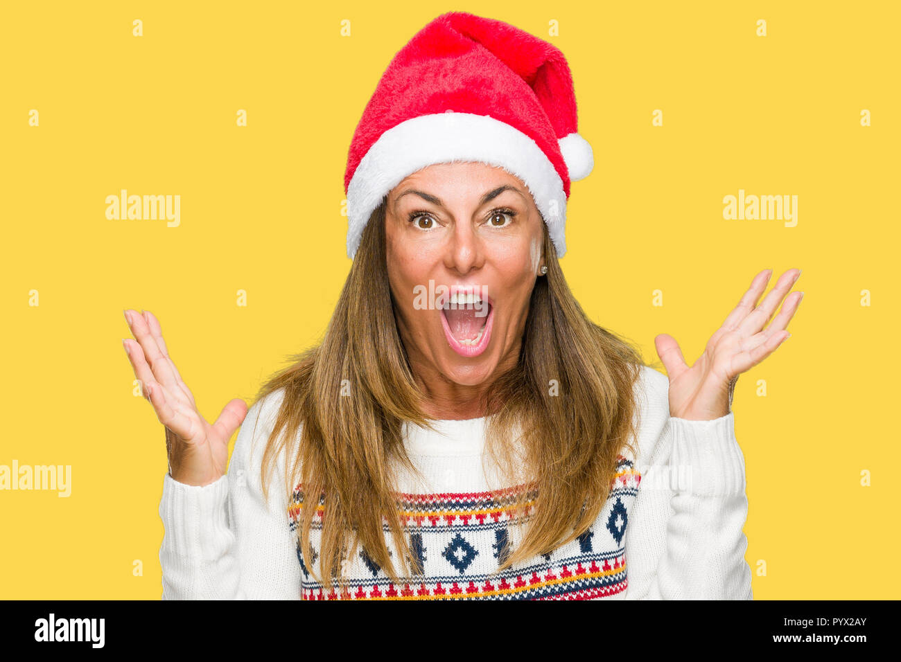 Middle age adult woman wearing winter sweater and chrismat hat over ...