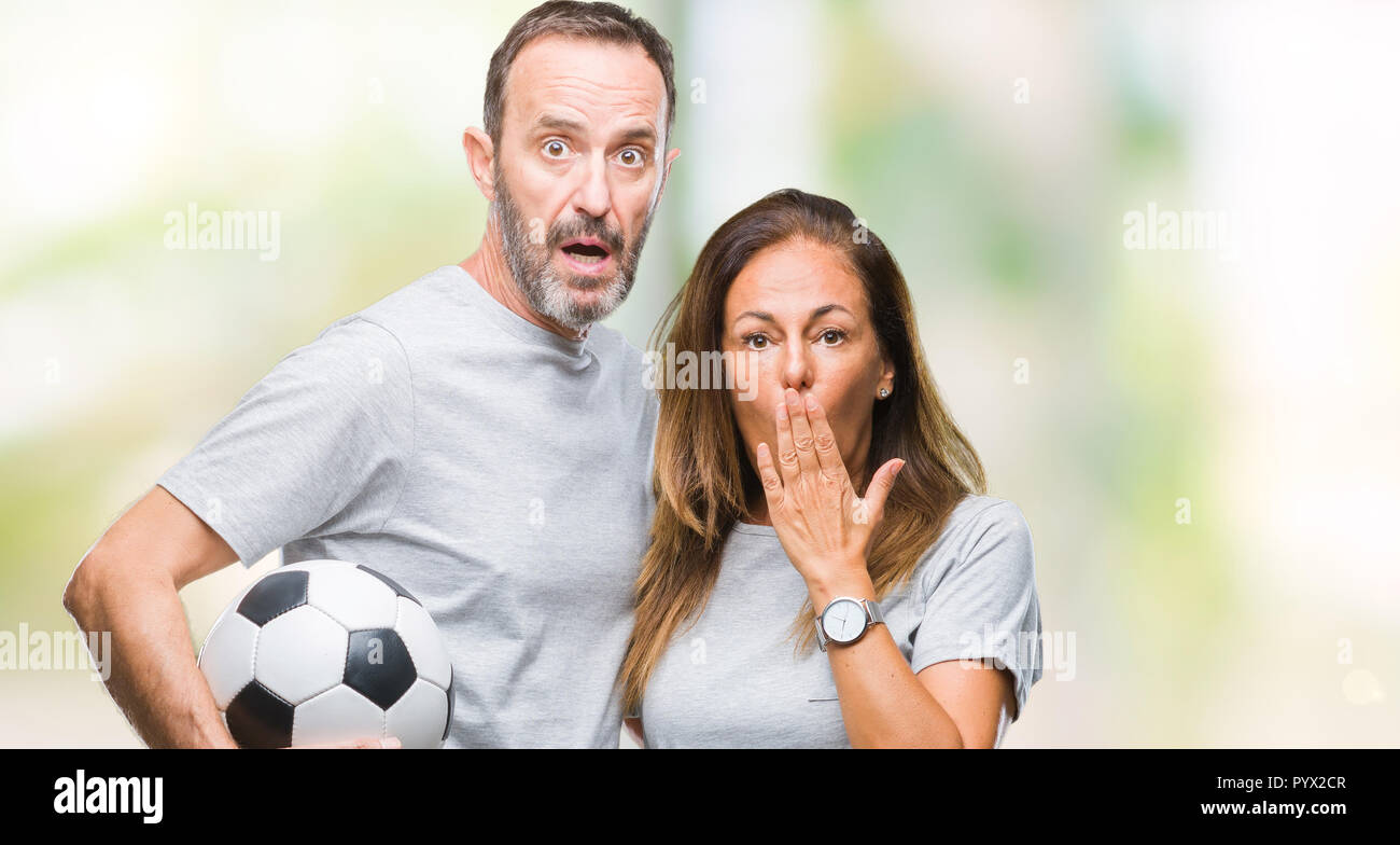 Middle age hispanic couple holding football soccer ball over isolated ...