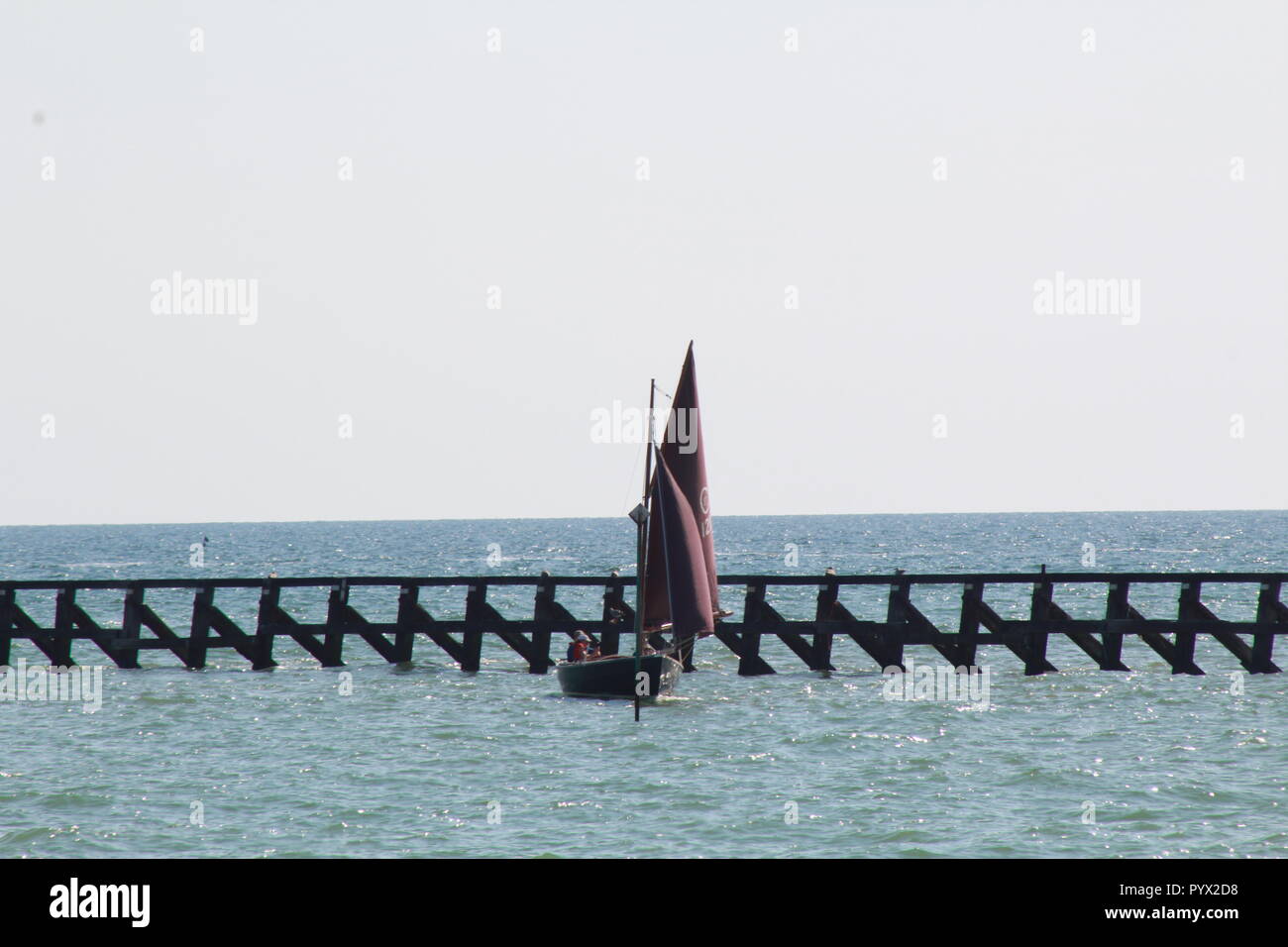 Yacht sailing into Littlehampton harbour Stock Photo - Alamy