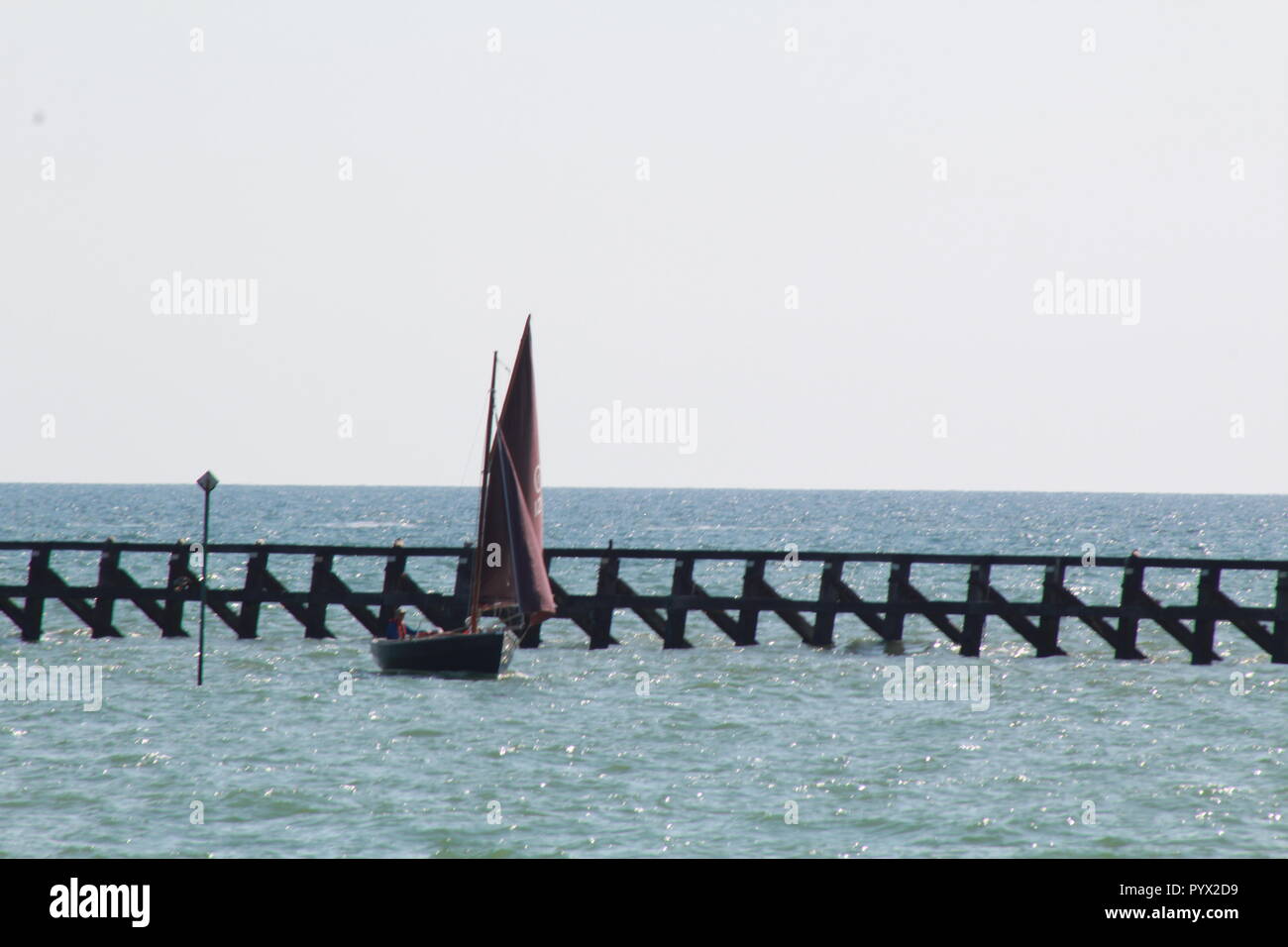Yacht sailing into Littlehampton harbour Stock Photo - Alamy