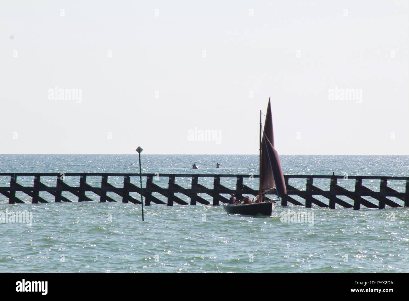 Yacht sailing into Littlehampton harbour Stock Photo - Alamy