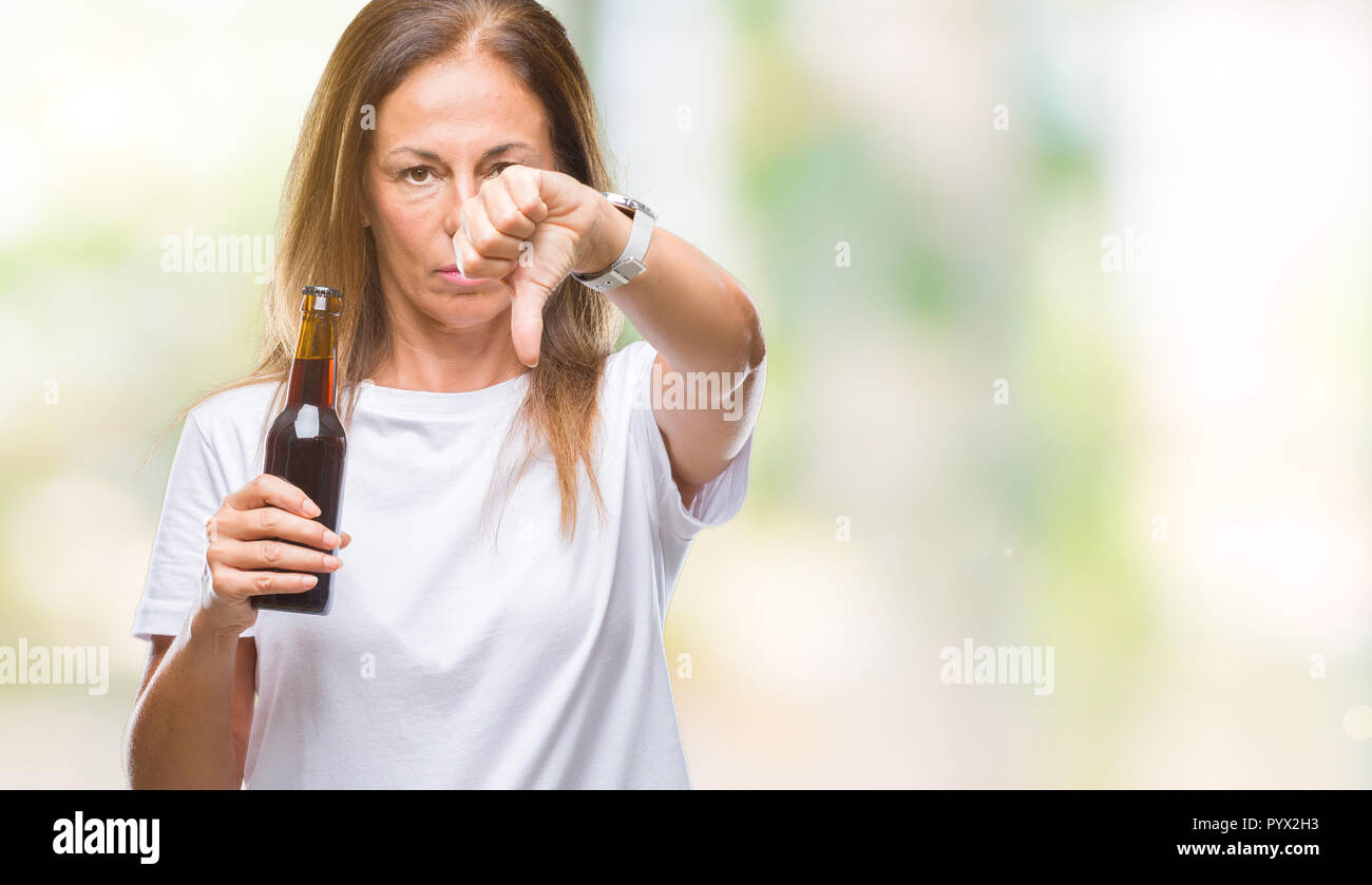 Middle age hispanic woman drinking beer over isolated background with ...