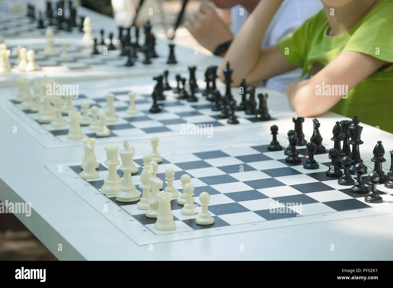 Children play chess outdoors in the summer Stock Photo - Alamy