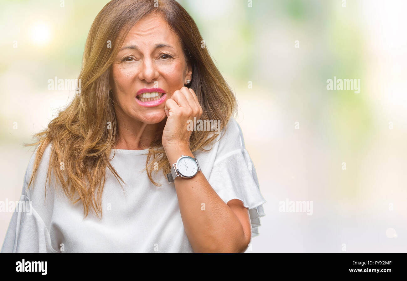 Middle age senior hispanic woman over isolated background looking ...