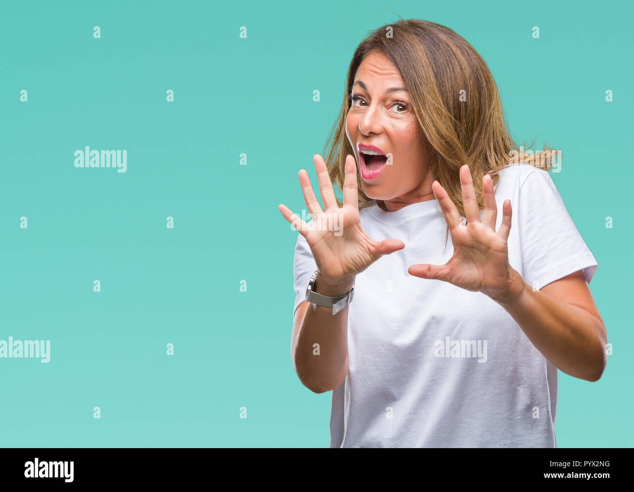 Middle age senior hispanic woman over isolated background afraid and ...