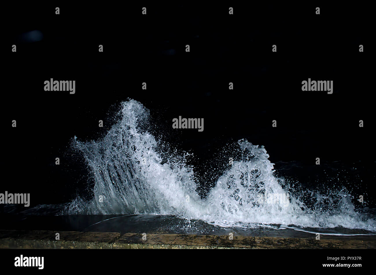 Splashing wave on the Black sea in the night Stock Photo - Alamy