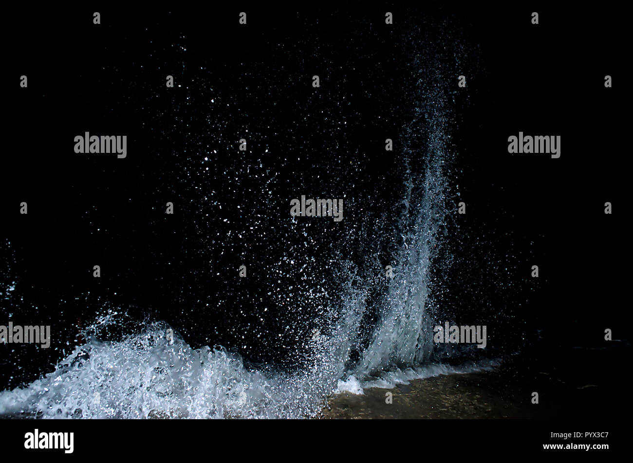 Splashing wave on the Black sea in the night Stock Photo - Alamy