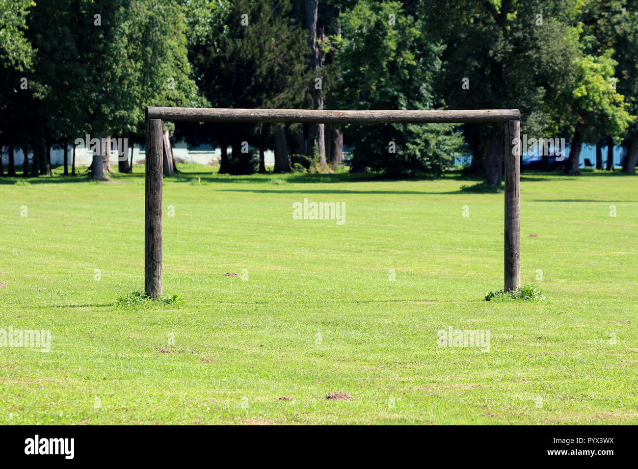 Goal post for soccer practice made of strong wooden logs in middle of ...