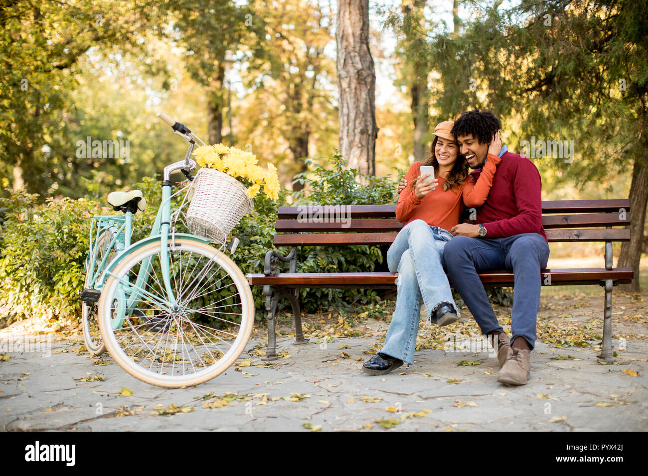 Loving couple sitting on bench hi-res stock photography and images - Alamy