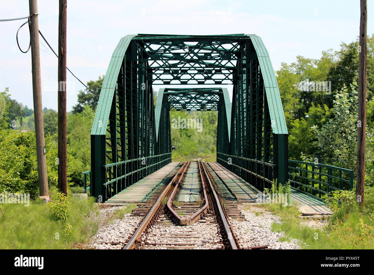 Metal railway bridge construction with railway tracks connected with ...