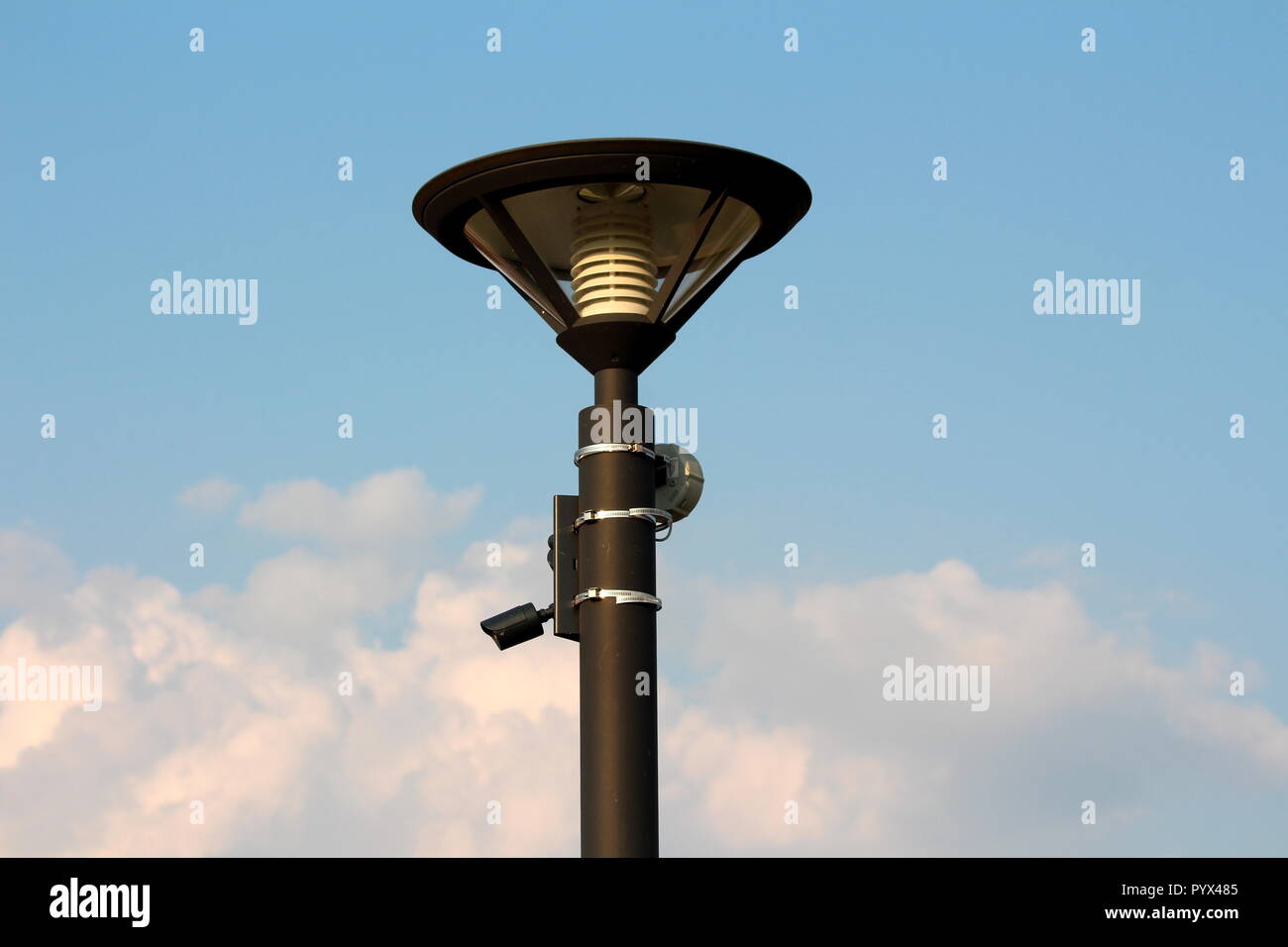 Modern metal black street lamp post with LED lightning and small ...