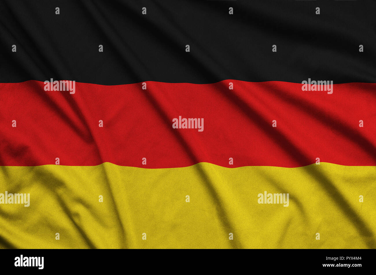 Germany flag is depicted on a sports cloth fabric with many folds ...
