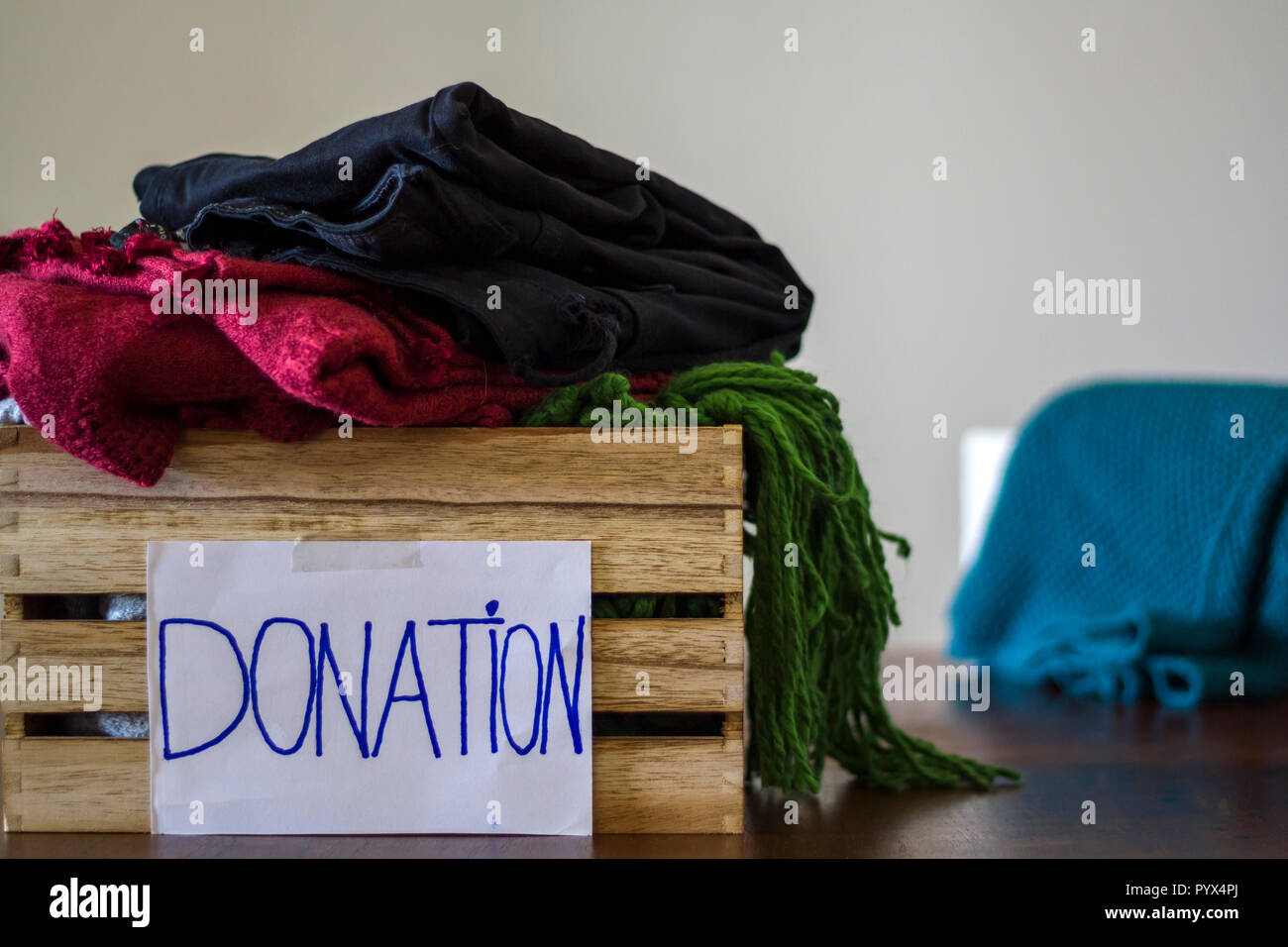 Clothes in box for concept donation Stock Photo - Alamy