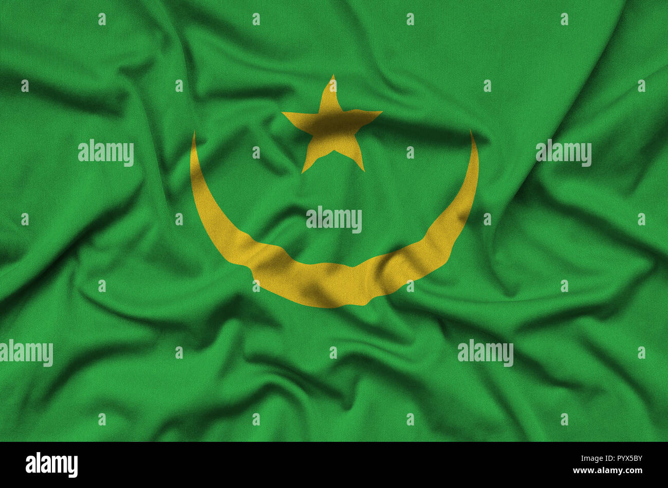 Mauritania flag is depicted on a sports cloth fabric with many folds ...
