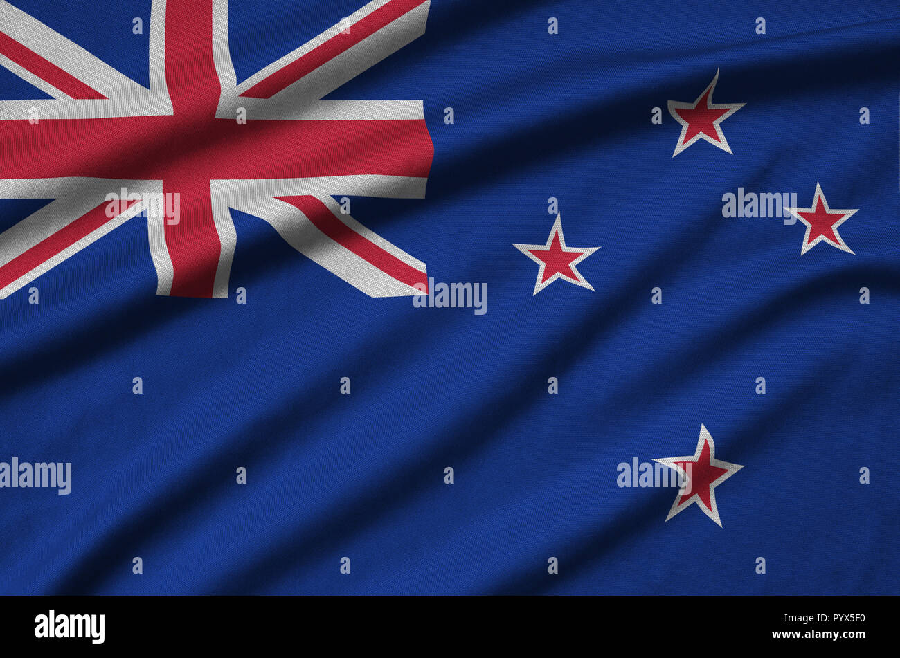 New Zealand flag is depicted on a sports cloth fabric with many folds ...