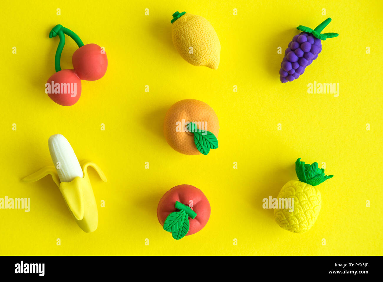 Rubber fruits isolated on yellow background minimal creative concept ...