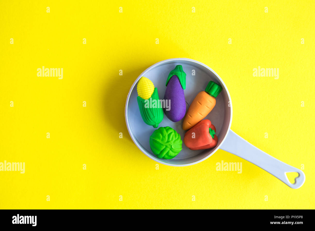 Rubber vegetables in plastic pan minimal creative concept Stock Photo ...
